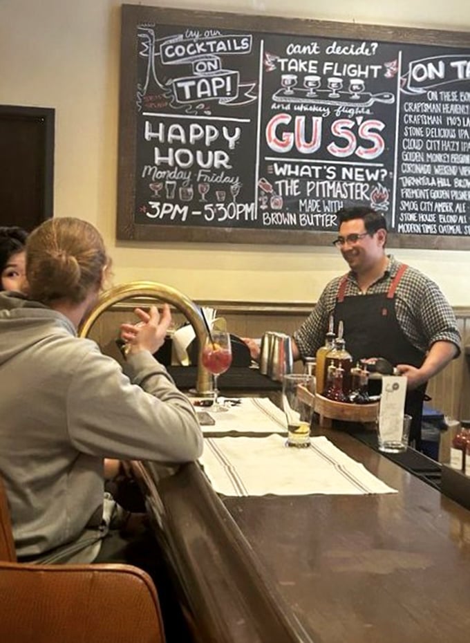 That chalkboard menu and friendly service remind you that barbecue isn't just food—it's a community gathering around smoke and fire. 