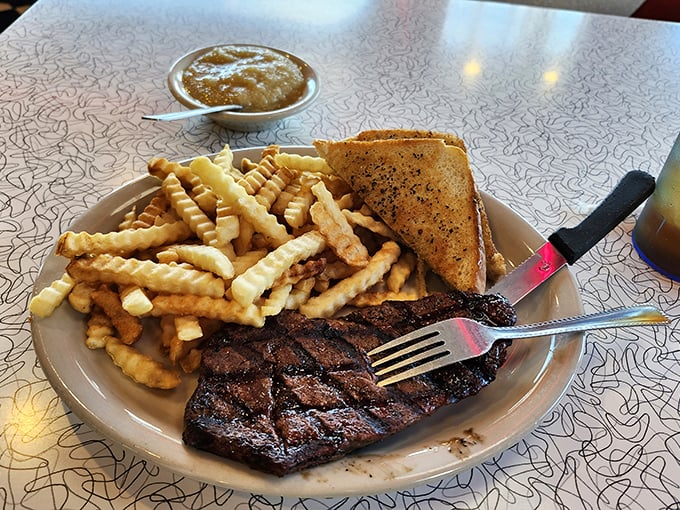 A steak that doesn't need fancy sauce or pretentious presentation—just respect for good beef and the skill to cook it right. Crinkle fries seal the deal.