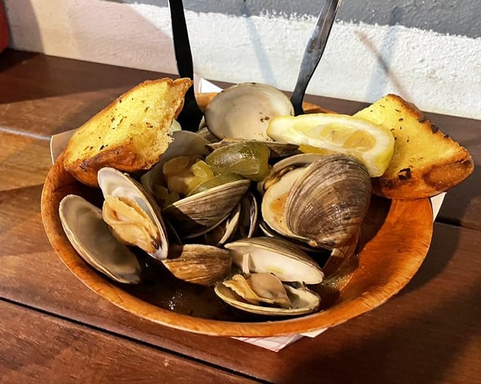 Steamed clams swimming in garlicky broth—a wooden bowl of treasures that would make Neptune himself order seconds.