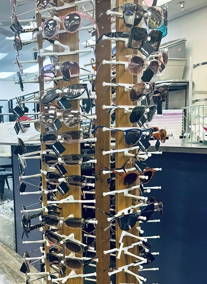 Sunglasses galore on their wooden carousel of cool—instant personality upgrades spinning lazily, waiting for their moment in the sun.