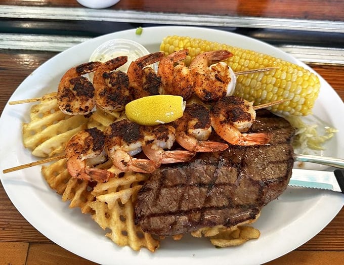 Surf meets turf in perfect harmony on a bed of waffle fries. This plate doesn't just satisfy hunger—it resolves existential crises.