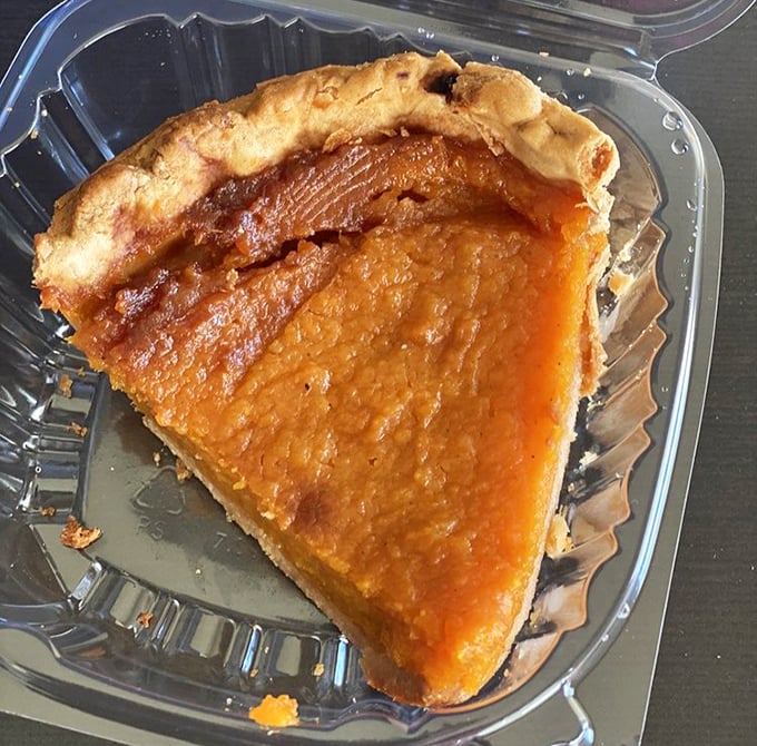 Sweet potato pie with a flaky crust that shatters just right – the kind of dessert that makes you question why anyone bothers with pumpkin.