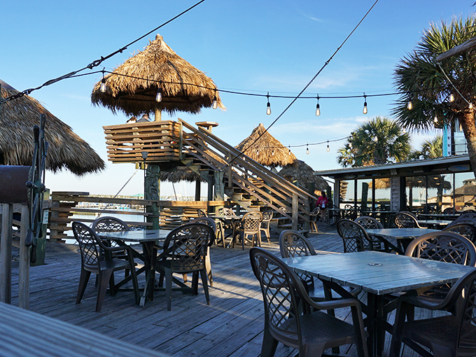 These elevated tiki huts aren't just dining areas—they're front-row seats to the daily water ballet of boats and birds.