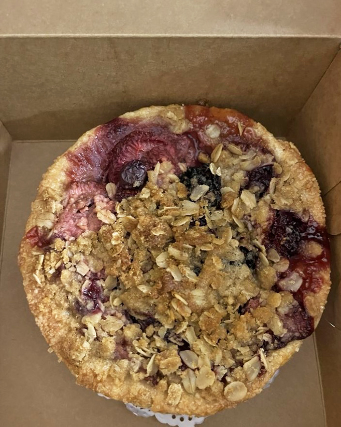 This triple berry mini pie isn't playing fair—the crumble topping, the glistening berries, the perfectly crimped crust. Resistance is futile.