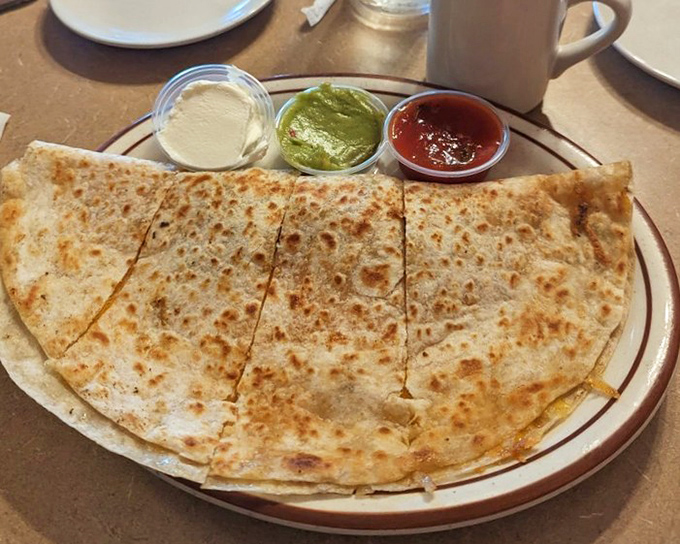 A quesadilla that's been hitting the gym—packed with fillings and served with the holy trinity of dips.