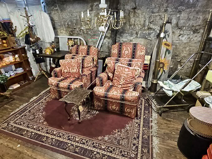 Vintage armchairs arranged like old friends catching up, that chandelier hanging above them like a crystal thought bubble of shared memories.