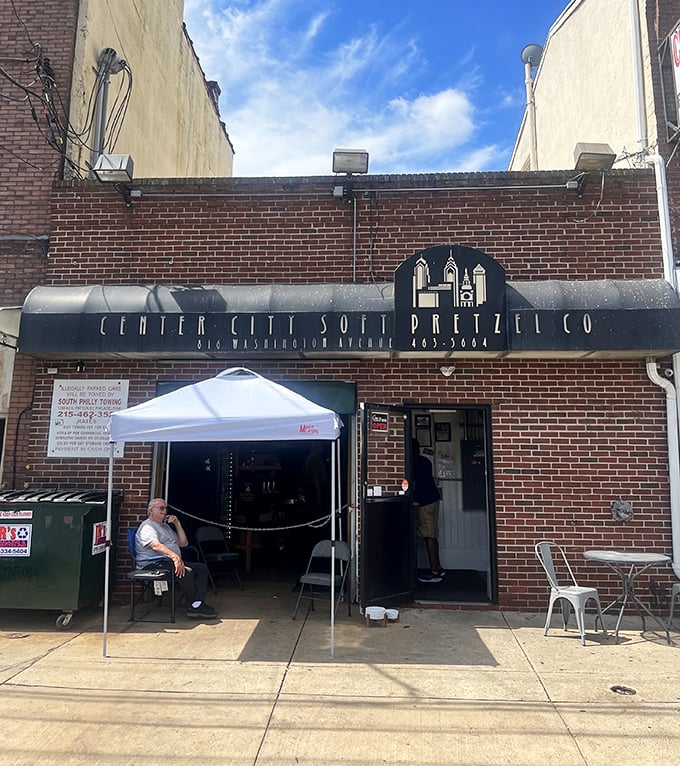 A humble sidewalk setup where pretzel pilgrims gather. In Philadelphia, this isn't just a bakery—it's a community gathering spot.