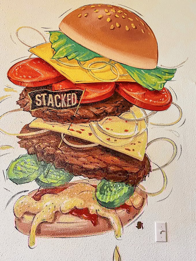 Wall art that speaks to your soul—a towering burger masterpiece that's both inspiration and challenge.