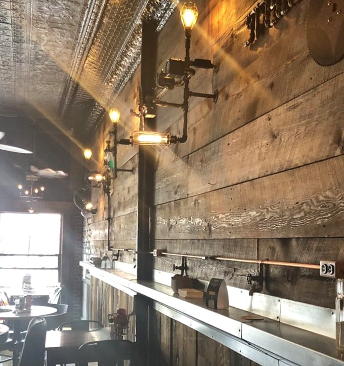 Industrial-chic lighting fixtures illuminate reclaimed wood walls – Edison would approve of both the bulbs and the atmosphere they create.