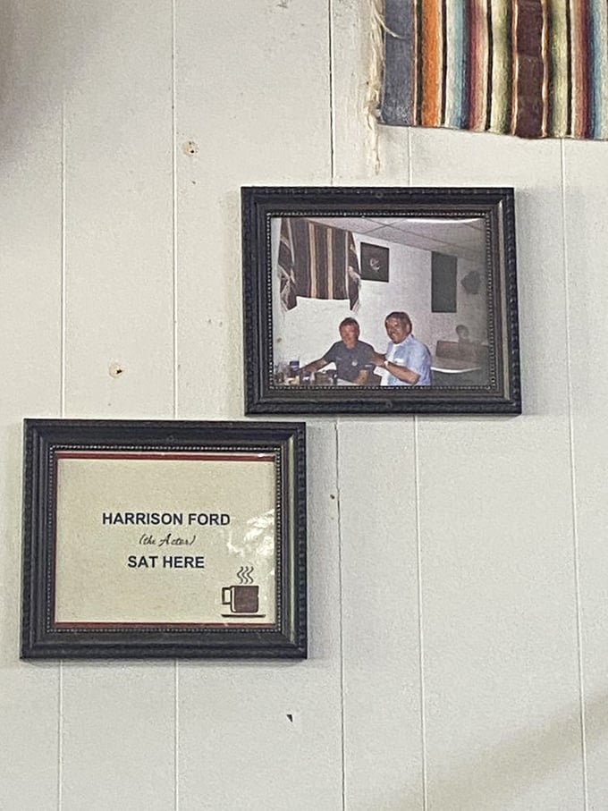 A framed reminder that even Harrison Ford needed to refuel here—celebrity endorsements don't get more authentic than a simple coffee cup icon.