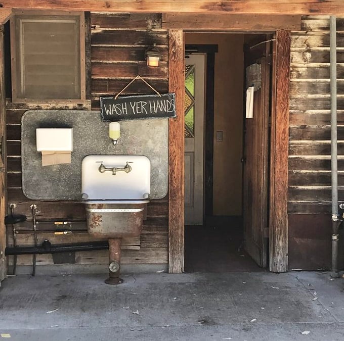 Even the wash area stays on theme—rustic, functional, and sporting the kind of straightforward instructions you'd expect from a no-nonsense establishment.