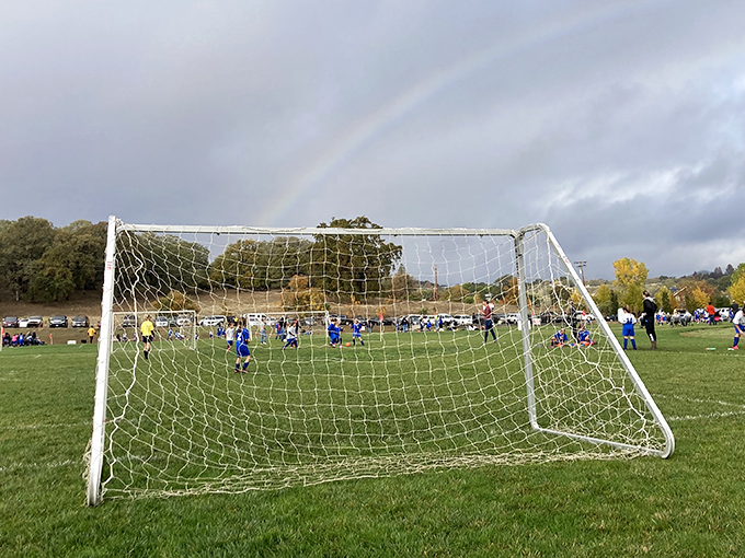 Soccer under rainbows at Westside Community Park—where kids play the beautiful game while nature provides the spectacular backdrop for free.