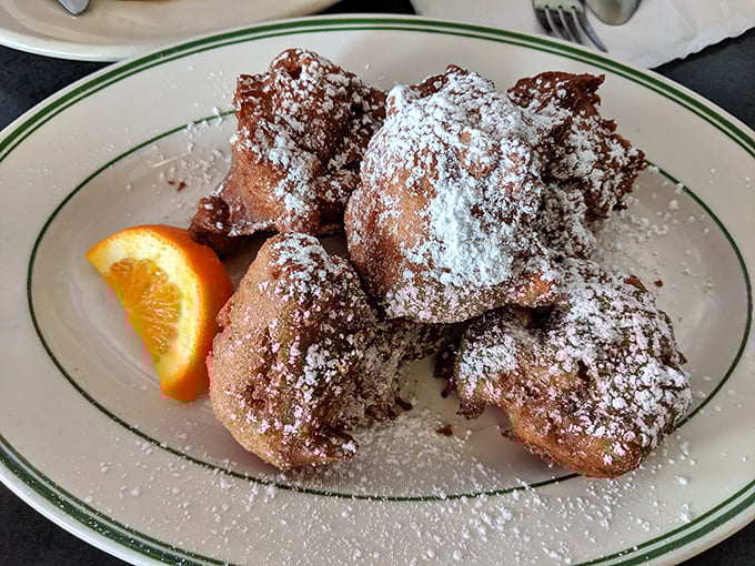 These apple fritters aren't just fried dough—they're little powdered sugar-dusted clouds of happiness that make Monday feel like Saturday.