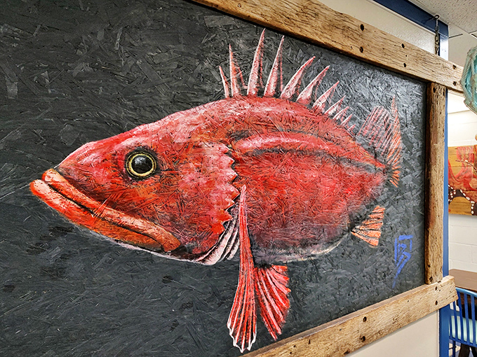 This isn't just fish art – it's a crimson rockfish portrait with personality, framed in weathered wood that's probably seen as many storms as the fish it depicts.