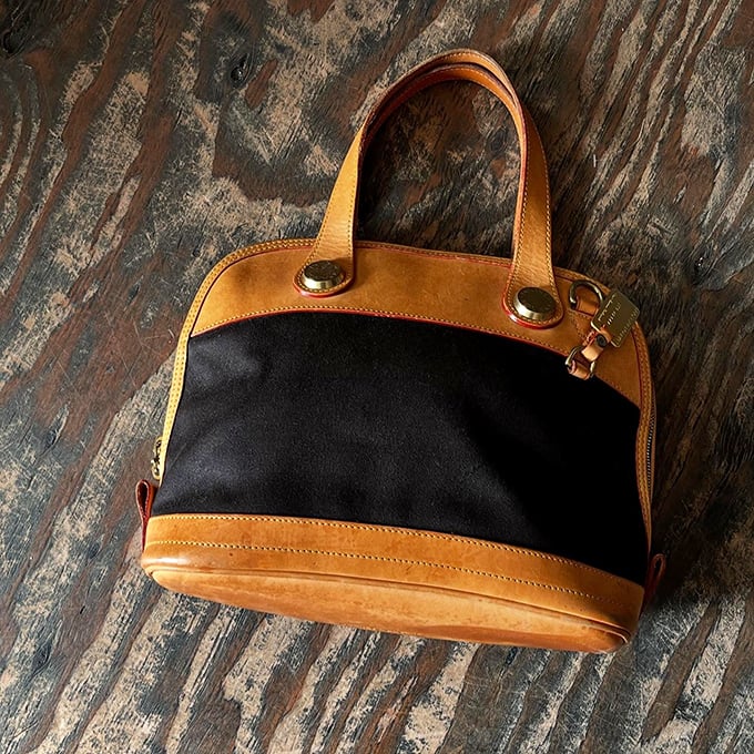 This two-tone leather handbag isn't just an accessory—it's a statement piece with stories to tell and new adventures to accompany.