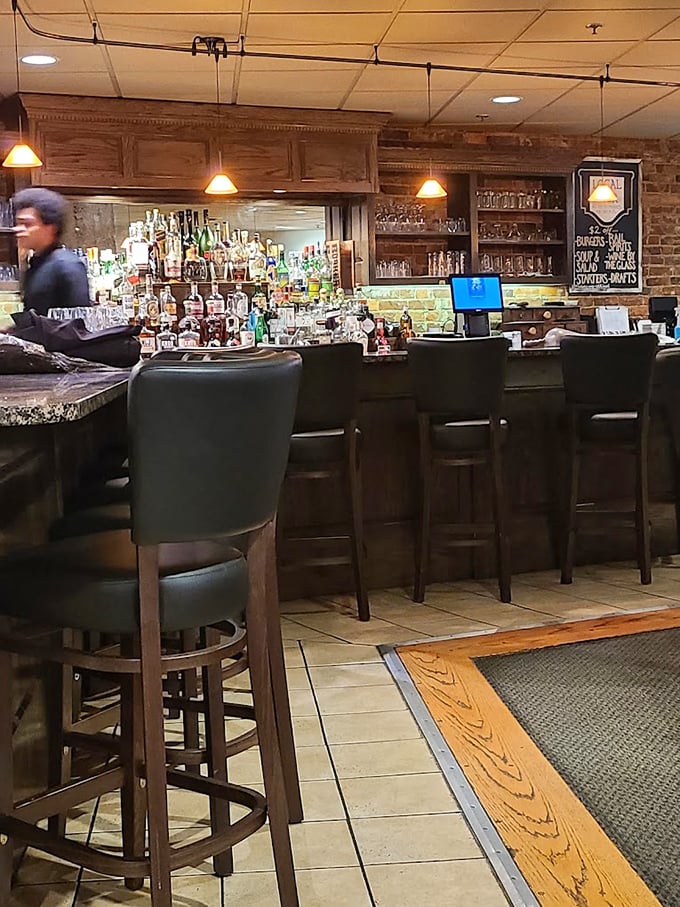 The bar area—where bourbon meets brick in a marriage that would make any Virginian proud. The perfect prelude to steak perfection.