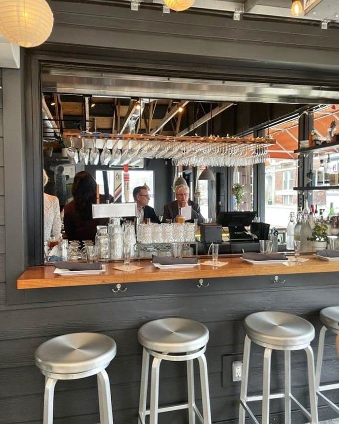 The bar isn't just for drinks – it's theater seating for the cocktail show, where glassware gleams and conversations flow as freely as the spirits.