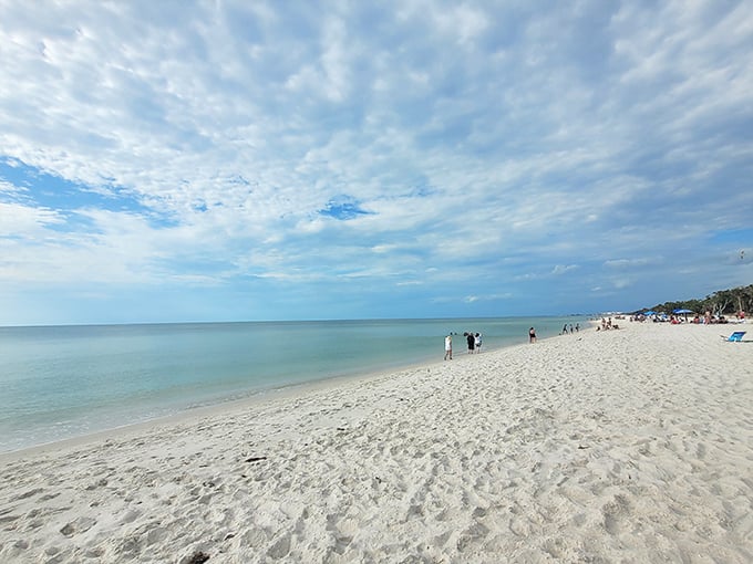 The beach stretches toward infinity, with just enough fellow humans to remind you you're not dreaming. Social distancing was invented here.