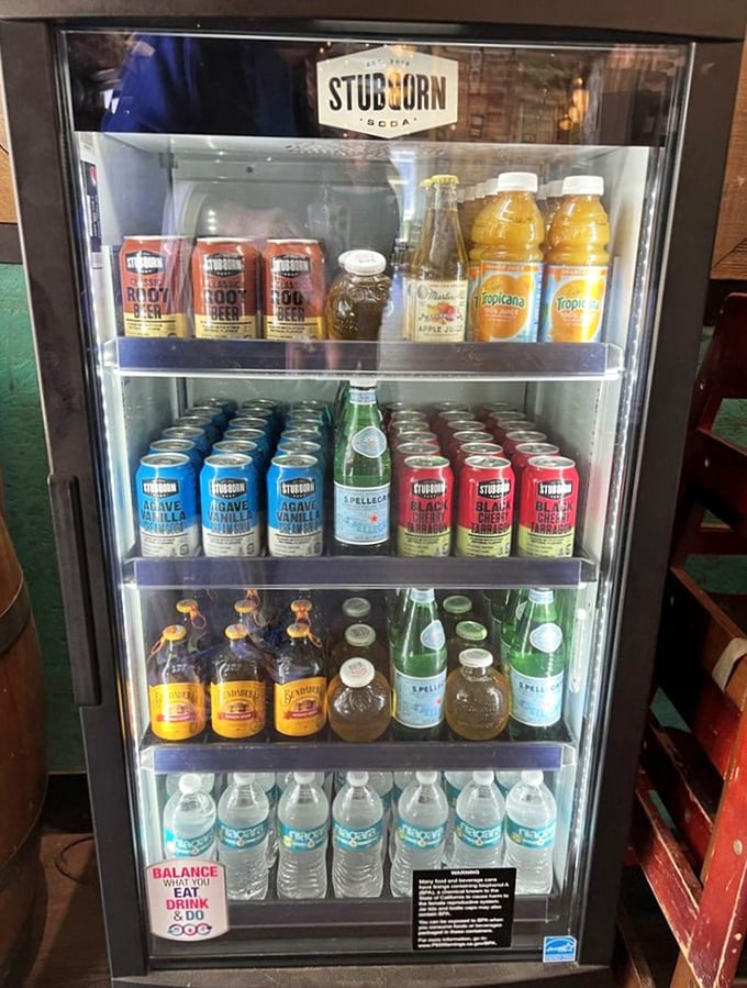 The beverage cooler—where craft sodas and local brews patiently wait to perform their sacred duty of washing down world-class barbecue.