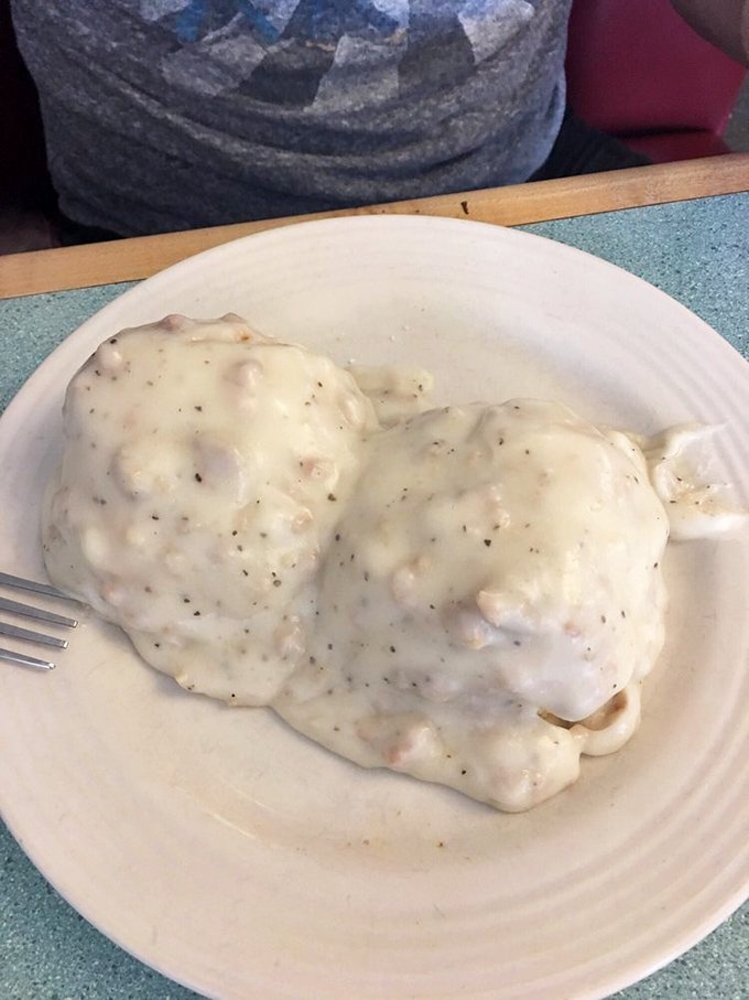 Biscuits and gravy that don't mess around – a cloud-like blanket of peppery white gravy that transforms humble biscuits into breakfast royalty.