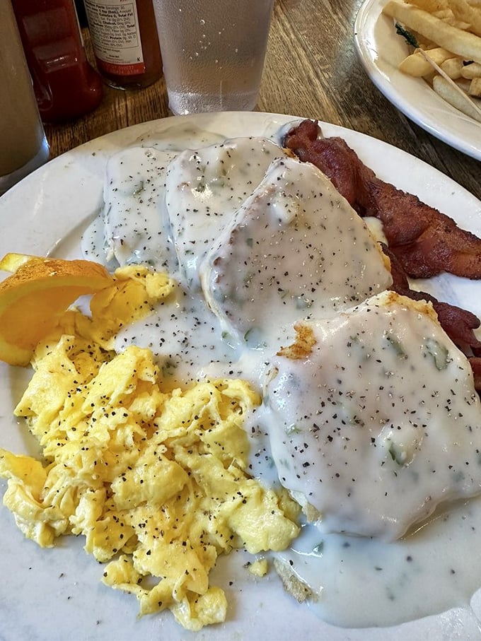 Behold the legendary biscuits and gravy—where pepper-speckled cream sauce blankets fresh-baked biscuits with the tenderness of a lullaby.