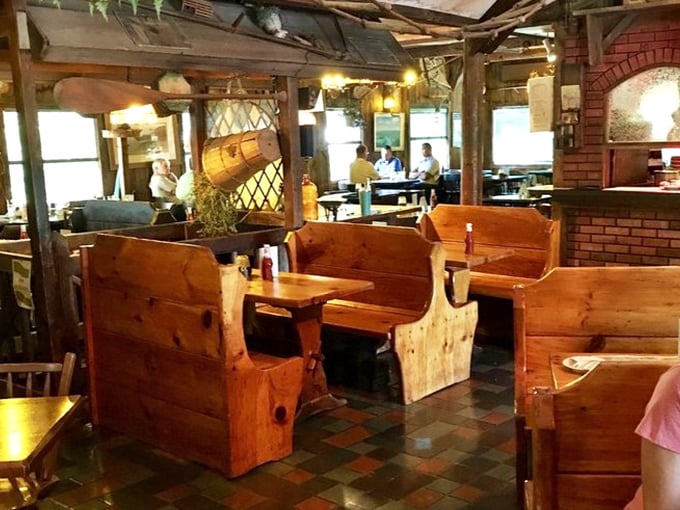 These wooden booths aren't just seating—they're private dining rooms where family stories unfold between bites of prime rib and sips of local wine.