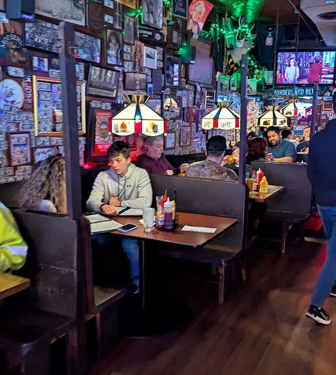 Booths bathed in the warm glow of vintage lamps. The walls aren't decorated—they're insulated with decades of memories and memorabilia.