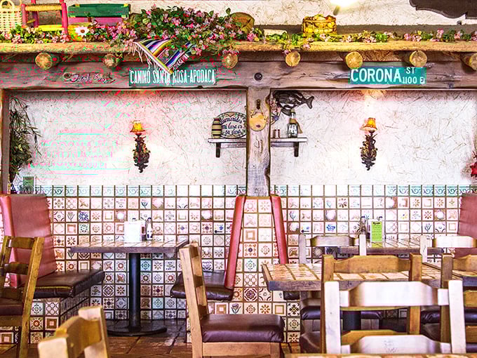 Booth seating adorned with Corona street signs and colorful tiles. The perfect backdrop for conversations that flow as easily as the salsa.