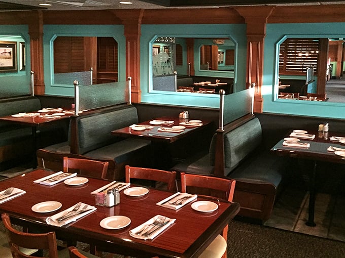Booths designed for privacy and tables set for celebration. The turquoise accents remind you that yes, you're definitely in Florida now.