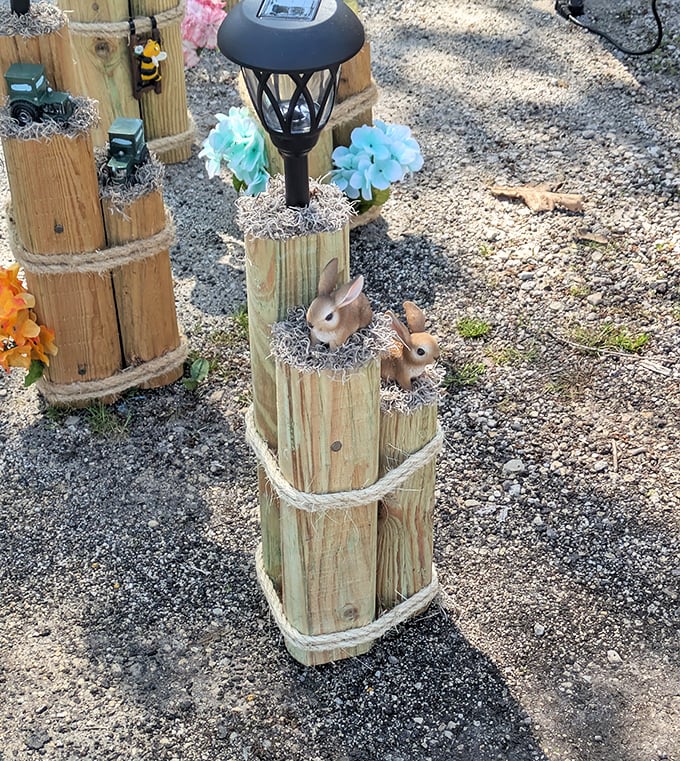 Garden whimsy comes alive with these charming wooden post creations—where solar lights and decorative bunnies transform ordinary yards into storybook settings.