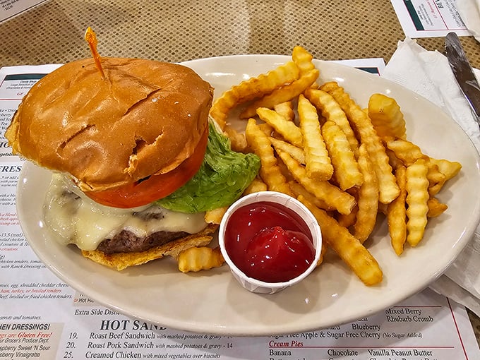 A towering burger with melted cheese and crispy fries proves that sometimes bigger really is better done right.