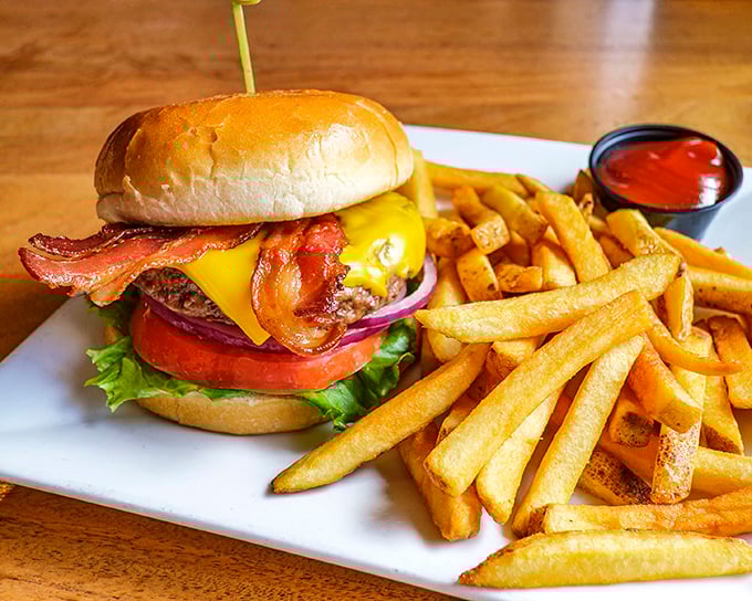 This isn't just a burger—it's architecture with cheese, where every layer from the crispy bacon to the melted American creates a symphony of satisfaction.