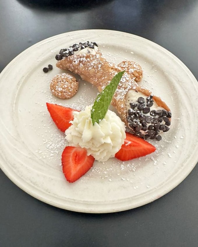 A cannoli that bridges continents – Sicily meets California in a dessert that's both delicate and decadent, with strawberries adding a fresh finale.