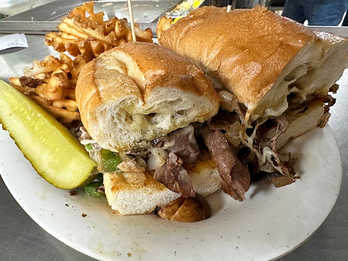 A sandwich that requires both hands and a strategy. This cheesesteak isn't just lunch – it's an engineering marvel that demands respect and napkins.