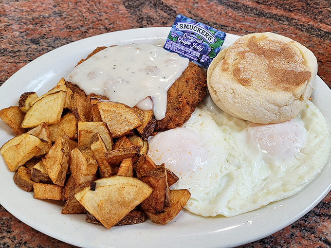Chicken fried steak smothered in country gravy alongside sunny-side-up eggs—a plate that says "you won't need dinner" in the most delicious way.