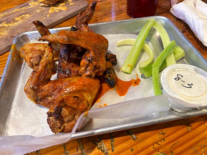 These wings aren't messing around – substantial, perfectly sauced, and served with the traditional celery sticks that nobody actually eats.