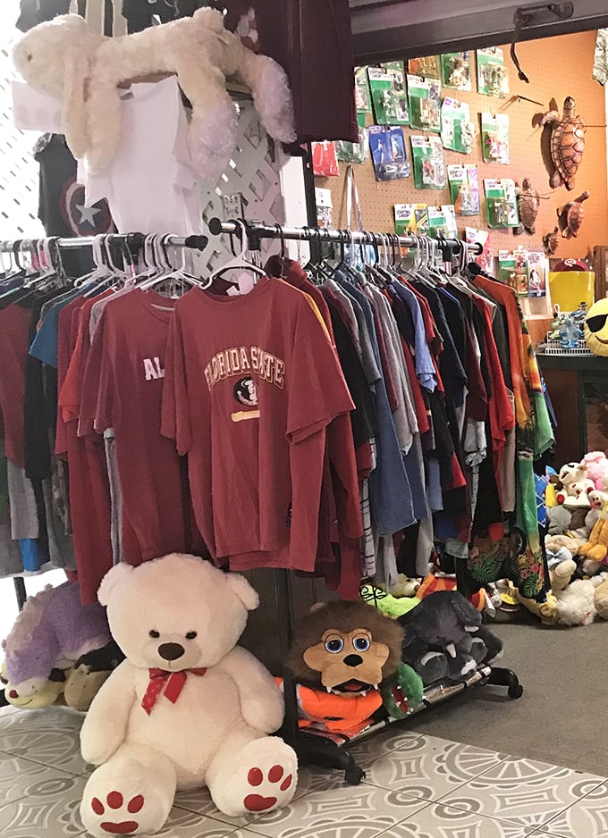 From college pride to cuddly companions, this booth has the perfect souvenir for fans and little ones alike. That teddy bear's seen some things.