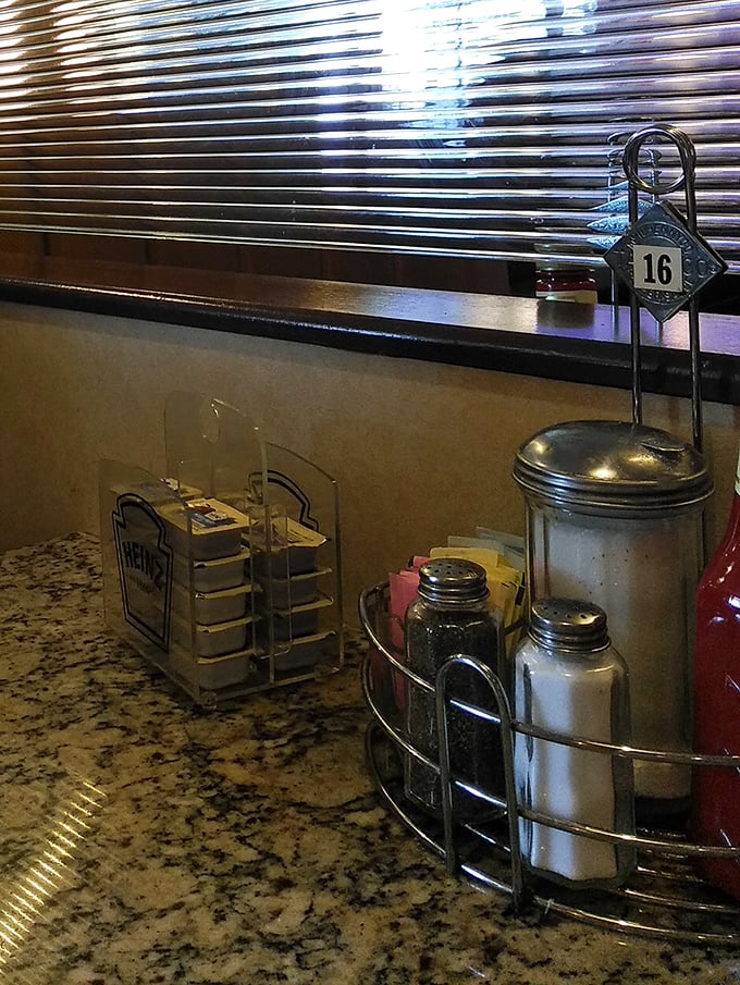Table 16 awaits its next lucky occupants, condiment caddy standing ready like a faithful soldier in the breakfast battlefield.