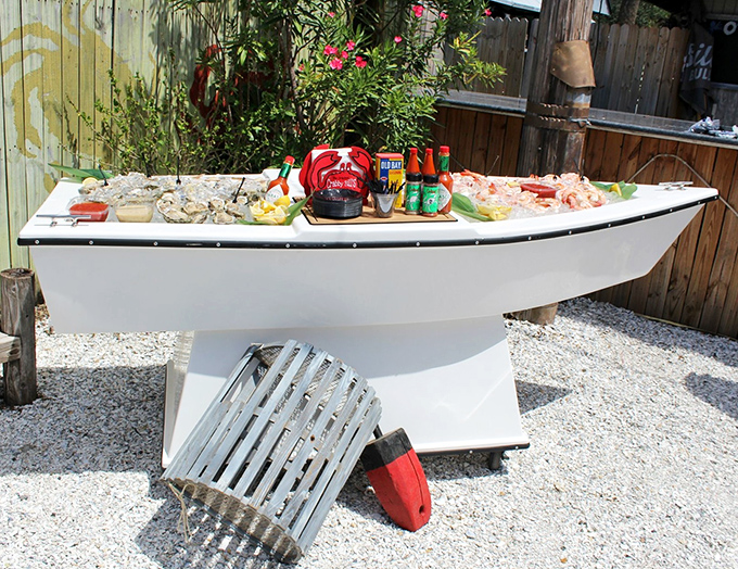 Not just a seafood display—it's a boat-shaped altar to oceanic delights, where condiments stand ready for their supporting roles.