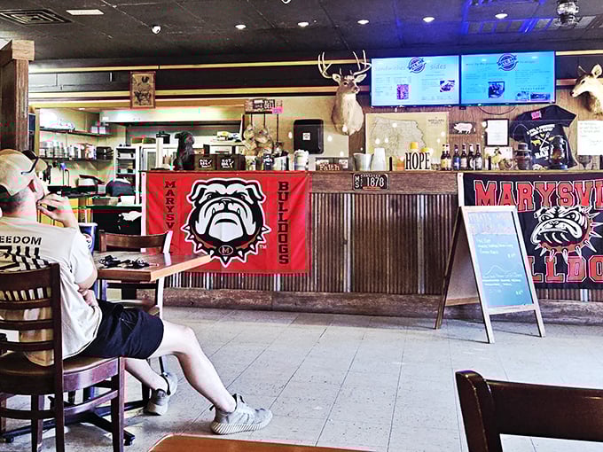 Behind that counter, barbecue magic happens daily. The mounted deer head isn't judging your order—he's jealous he can't join the feast.