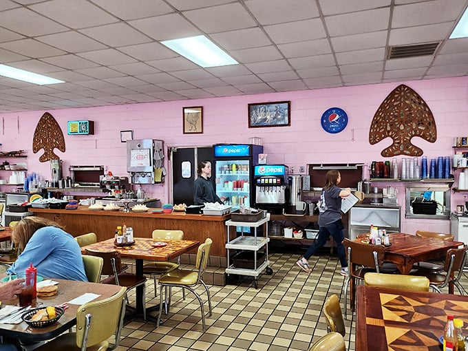 Behind the counter, where the magic happens—pink walls, vintage fixtures, and staff who know many customers by name and order.