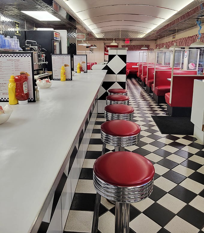 A row of empty red stools awaiting their next patrons—like front-row seats to the greatest show on earth: breakfast served all day.