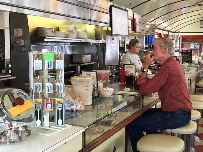 Counter culture at its finest—where regulars perch on swivel stools, trading stories over bottomless cups while watching their breakfast materialize before their eyes.