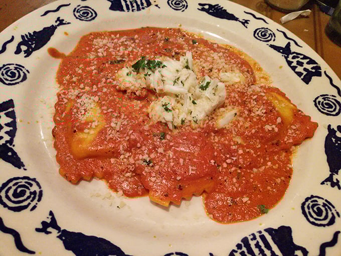The crab ravioli that launched a thousand return visits—pillowy pasta islands in a sea of tomato sauce topped with more crab because... why not?