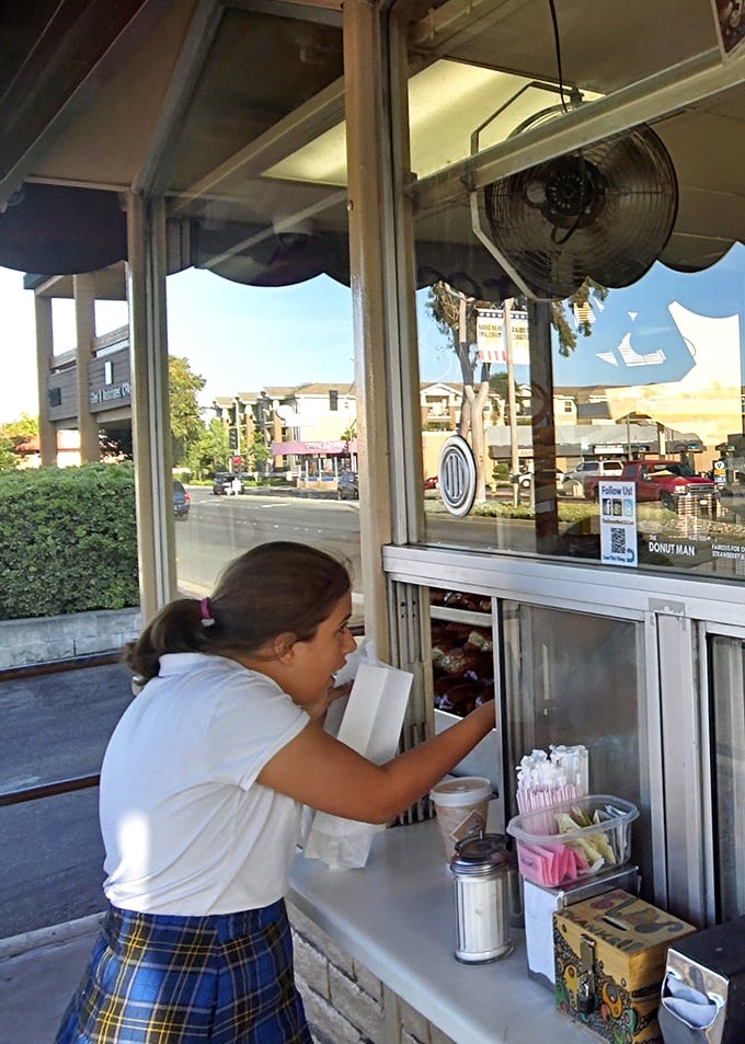 The walk-up window experience – a brief transaction that delivers outsized happiness in the form of a simple white box.