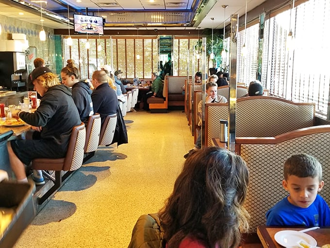 The counter seating: where solo diners become temporary neighbors and coffee refills flow like conversation. Democracy in action, with pancakes.