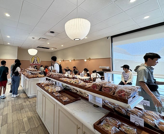 The bakery fills with eager customers navigating a sea of carbs with the focus of treasure hunters on a mission.