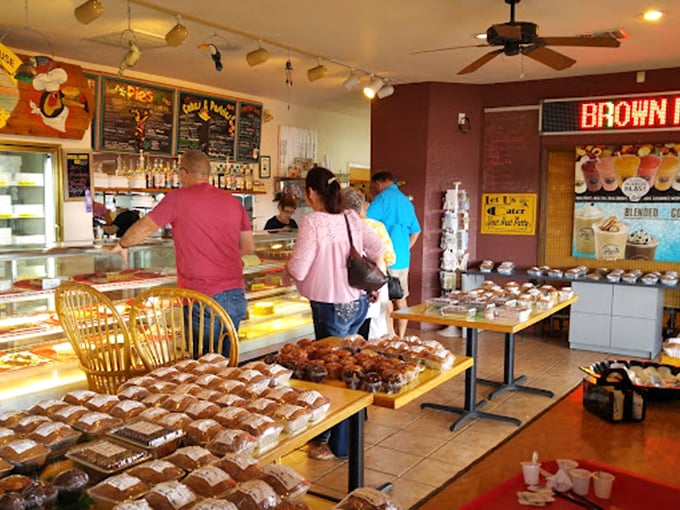 Customers contemplating their sweet destiny at the counter. That look of anticipation is universal—dessert decisions are serious business.