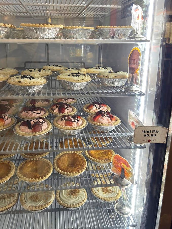A dessert case that stops conversations mid-sentence. Those mini pies aren't just desserts—they're individual works of art waiting to be devoured.