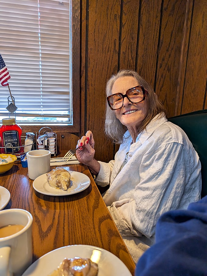 A happy diner enjoying her meal—the universal expression that says "I've found my happy place, and it comes with hash browns."